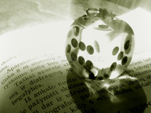 Dice on a book stock photo. Image of table, letter, scissors - 73634