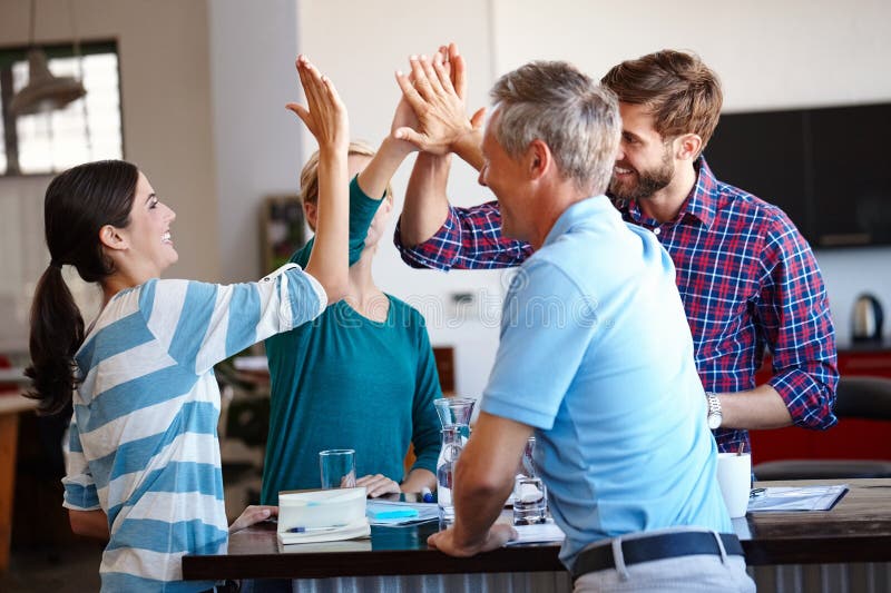We Did it. a Group of Coworkers High-fiving in an Office. Stock Photo ...