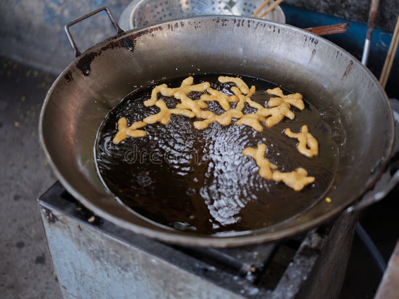 Die Cut of Deep Fried Chinese Doughnut in an Big Oil Pan Stock Image ...