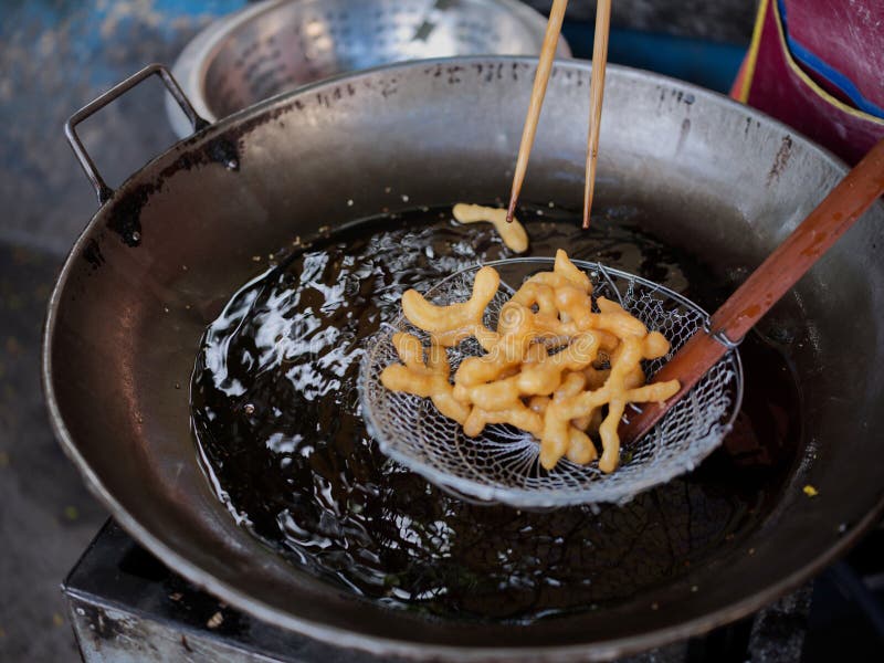 Die Cut of Deep Fried Chinese Doughnut in an Big Oil Pan Stock Image ...