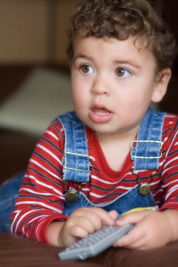 Diego Watching TV and Using the Remote Stock Photo - Image of learning ...