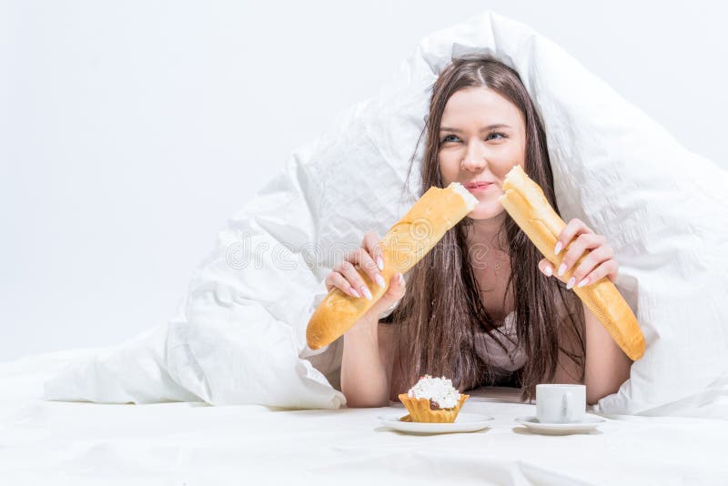 After the Diet. Woman Eats in a White Bed, Breakfast. the Brunette Lies ...