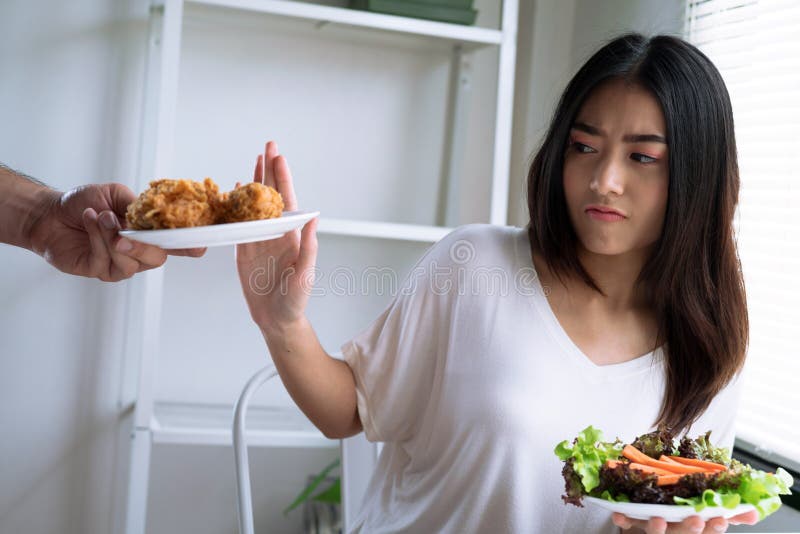 Young Woman Rejecting Junk Food And Choosing Healthy Food Such As Fresh