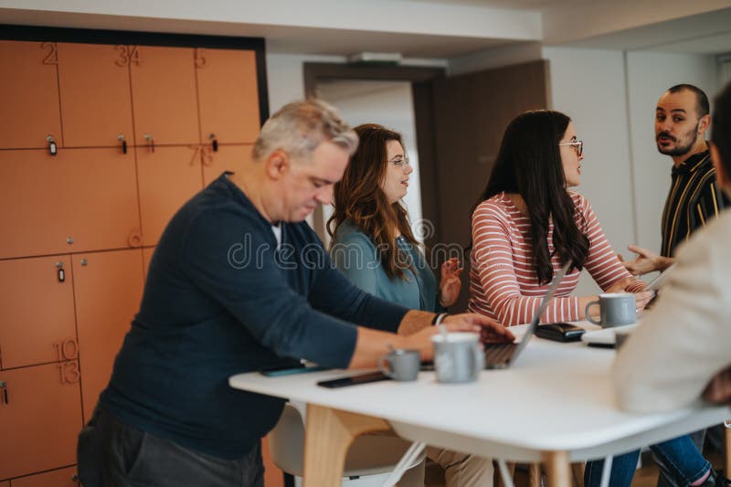 A Different Aged Group of Company Employees Engage in a Collaborative ...
