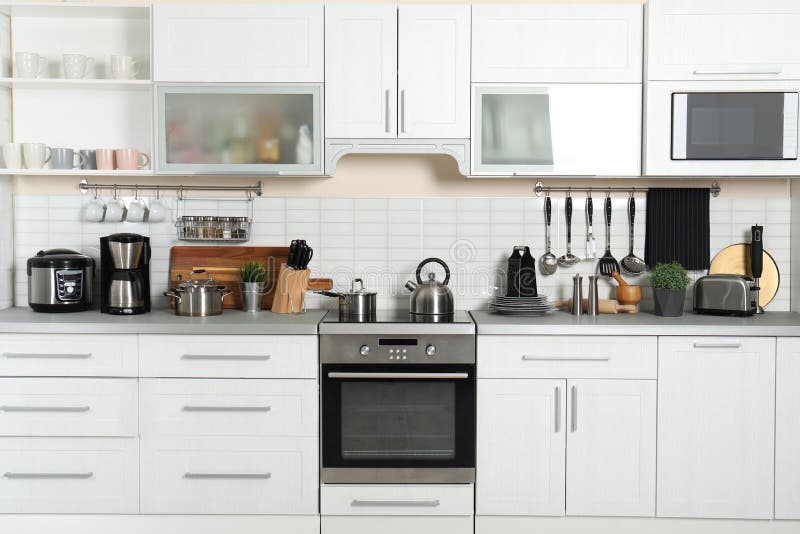 Different Appliances, Clean Dishes and Utensils on Kitchen Stock Photo ...