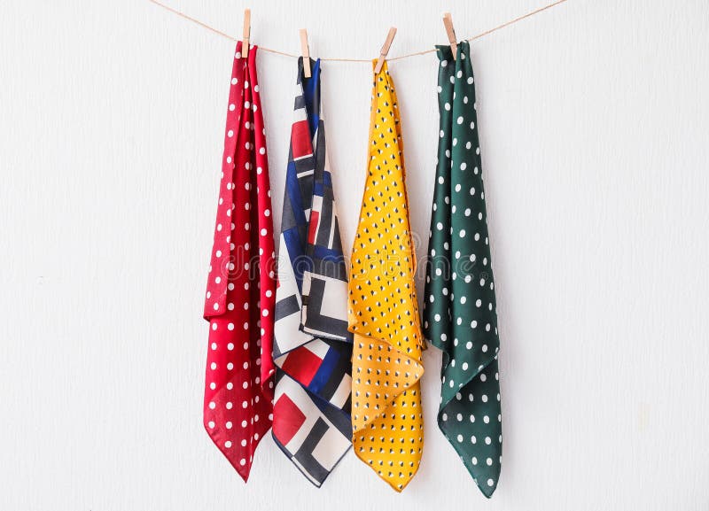 Different Beautiful Scarves Hanging on Rope Against White Background ...