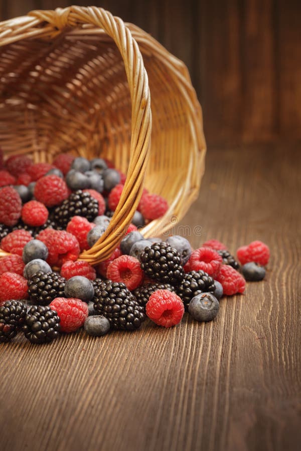 Different Berries in a Basket on a Wooden Table Stock Photo - Image of ...