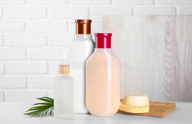 Different Bottles of Shampoo and Green Leaf on White Table Stock Photo ...