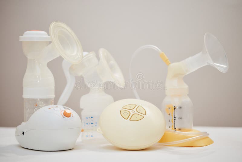 Different Breast Pumps on Table. Maternity and Child Care. Stock Photo ...