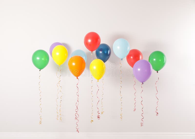 Different Bright Balloons Against Light Wall. Stock Photo - Image of ...
