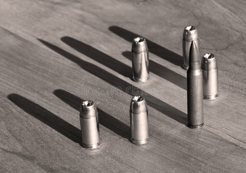 Different Bullets on a Wooden Table in Black and White Stock Photo ...