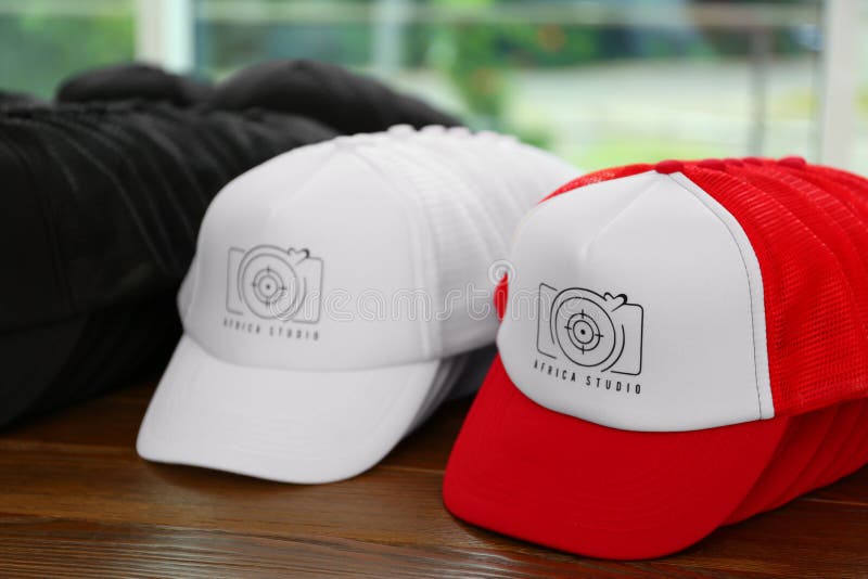 Different Caps with Logo on Table Stock Photo - Image of label, modern ...