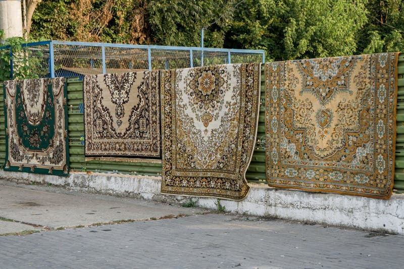 Different Carpets Hanging on Rack Outdoors. Professional Carpet ...