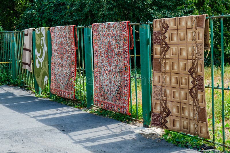 Different Carpets Hanging on Rack Outdoors. Professional Carpet ...