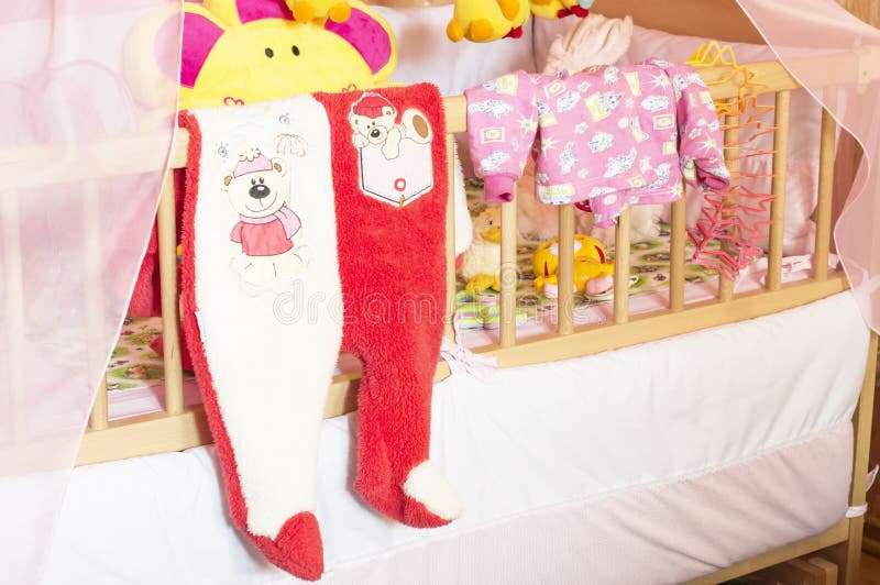 Different Children S Clothes and Toys in the Cot Stock Image - Image of ...