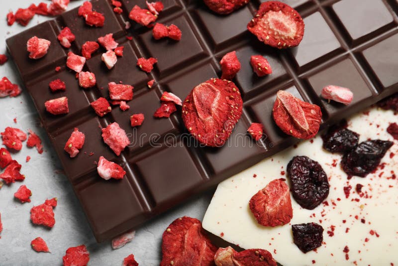 Different Chocolate Bars with Freeze Dried Fruits on Light Marble Table ...