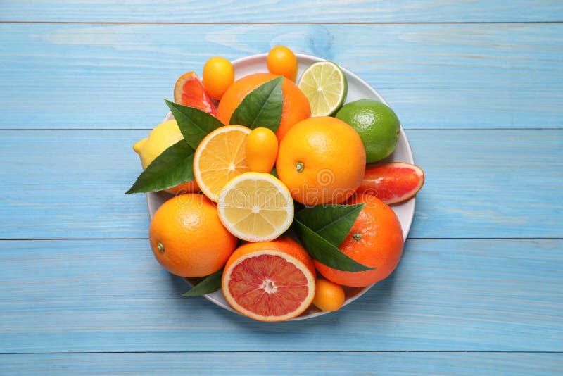 Different Citrus Fruits on Light Blue Wooden Table, Top View Stock ...