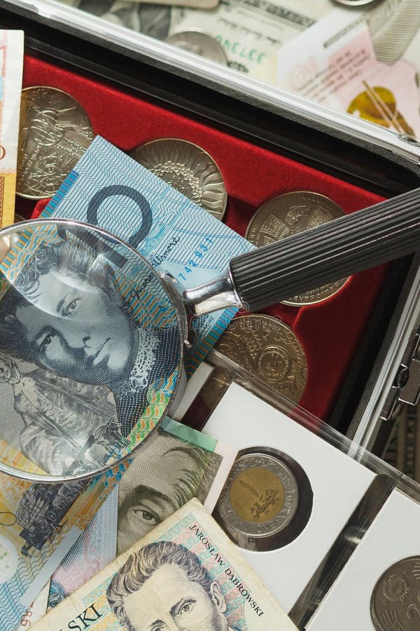 Different Collector`s Coins and Banknotes with a Magnifying Glass Stock ...