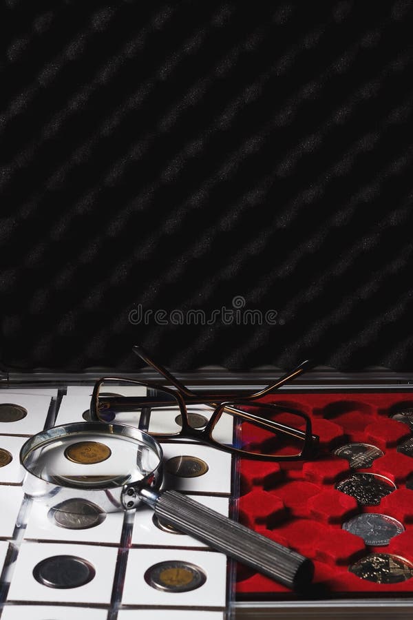 Different Collector`s Coins in the Box for Coins and a Magnifying Glass ...