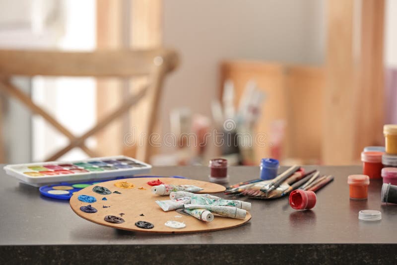 Different Color Paints and Wooden Palette on Table Stock Image - Image ...