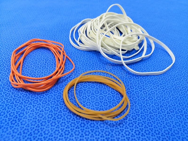 Different Color Rubber Bands in Blue Background Stock Photo - Image of ...