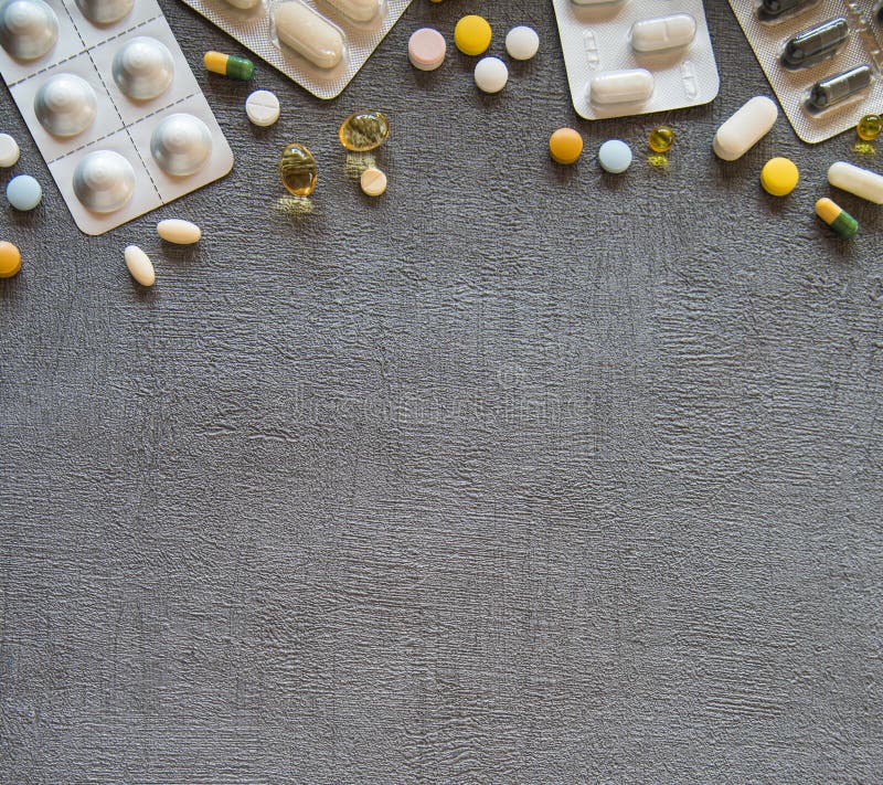 Different Colored Medications and Tablets on Grey Texture Background ...