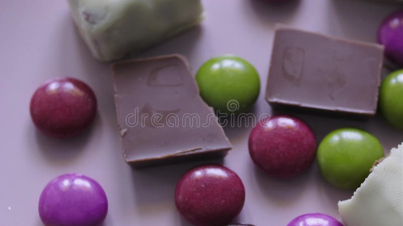 Different Colored Spots and Chocolates on Pink Plate Stock Video ...