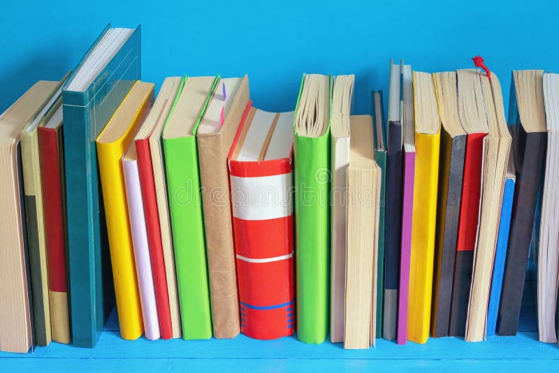 Different Colorful Books on Blue Bookshelf. Copy Space Stock Image ...