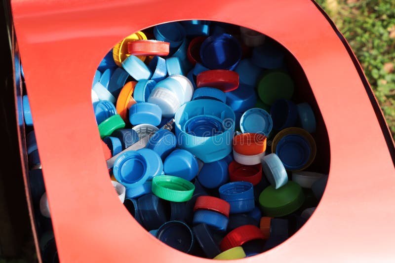 Different Colorful Bottle Caps in Red Bin. Plastic Recycling Stock ...