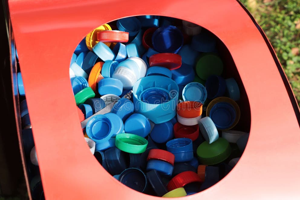 Different Colorful Bottle Caps in Red Bin. Plastic Recycling Stock ...