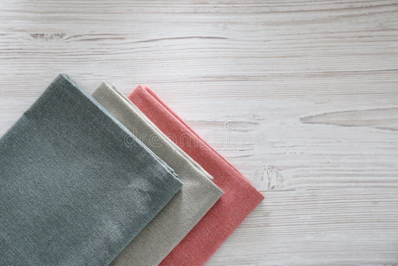 Different Colorful Napkins on White Wooden Table, Top View. Space for ...