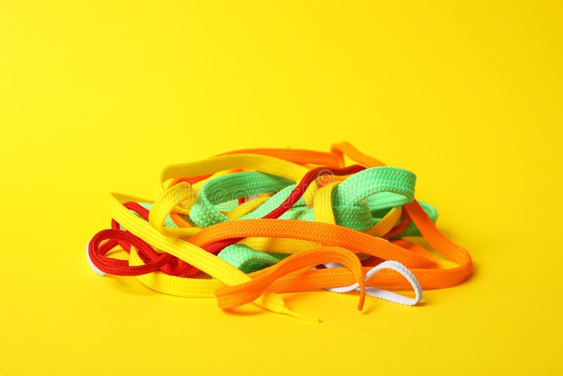 Different Colorful Shoe Laces on Yellow Background Stock Photo - Image ...