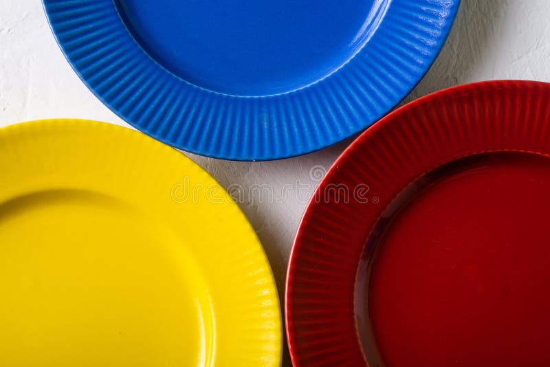 Different Colors of Empty Plates. White Background. Red, Blue and ...