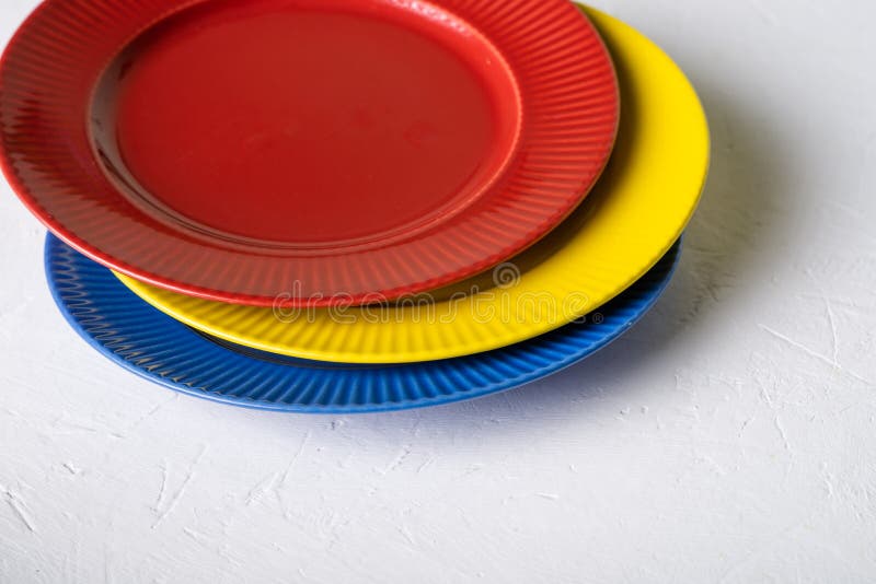 Different Colors of Empty Plates. White Background. Red, Blue and ...