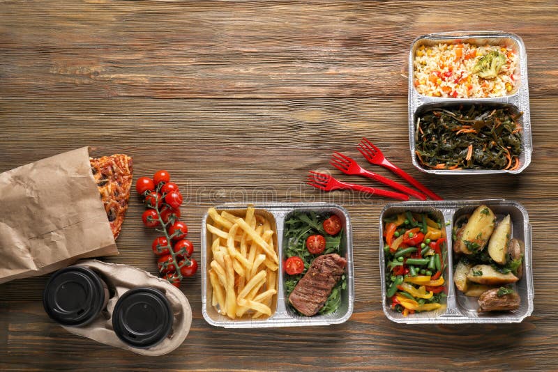 Different Containers with Delicious Food on Wooden Table. Delivery ...