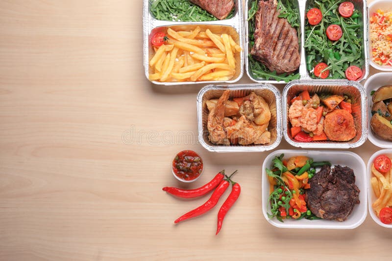 Different Containers with Delicious Food on Wooden Table. Delivery ...