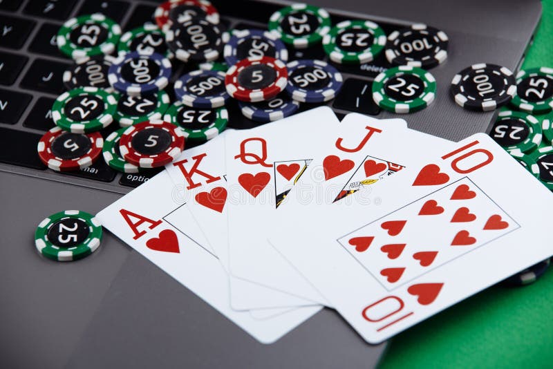 Different of Cost Casino Chips Stacking and Playing Cards on a Laptop ...