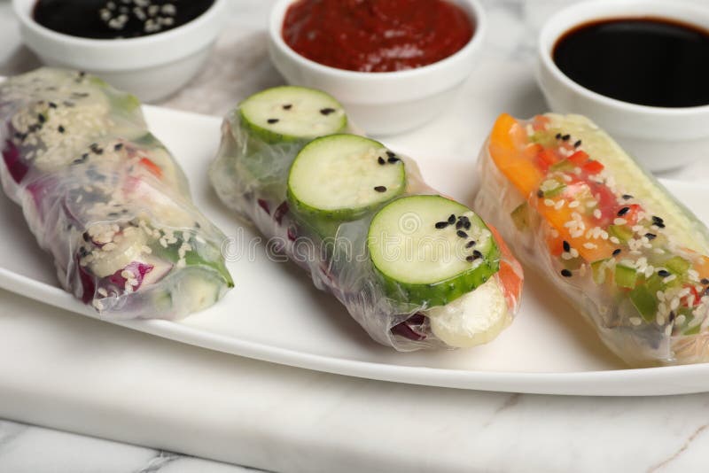 Different Delicious Rolls Wrapped in Rice Paper on White Marble Board ...