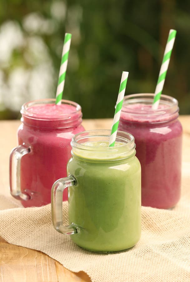 Different Delicious Smoothies in Mason Jars on Wooden Table Against ...
