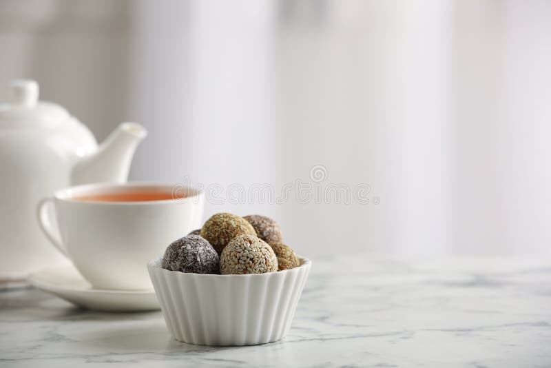 Different Delicious Vegan Candy Balls and Tea on White Marble Table ...