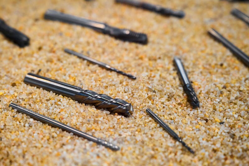 Different Drilling Tools on Sand Surface in Workshop Stock Photo ...