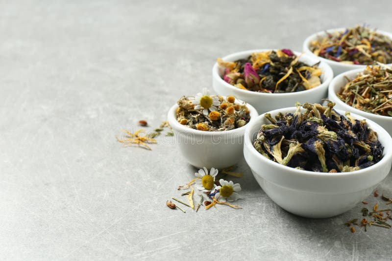 Different Dry Aromatic Teas on Light Grey Table, Space for Text Stock ...