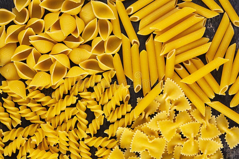 Different Dry Pasta on a Wooden Background. Top View Stock Photo ...
