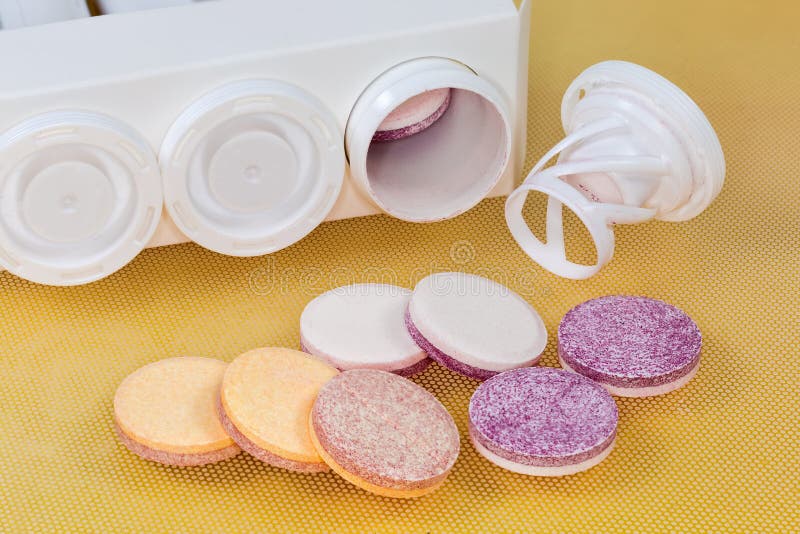 Different Effervescent Tablets Against the Their Packagings on Yellow ...