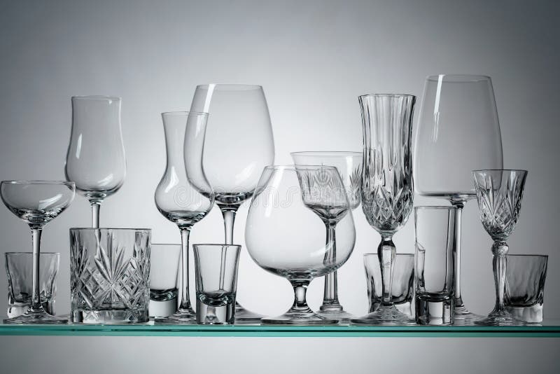 Different Empty Glasses on a Glass Shelf Stock Photo - Image of ...