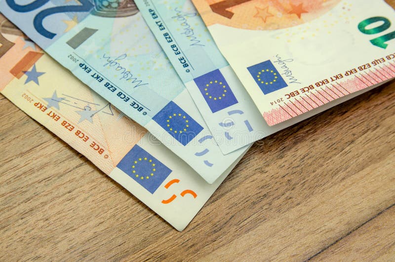 Different Euro Banknotes on Wooden Stock Photo - Image of cash, finance ...
