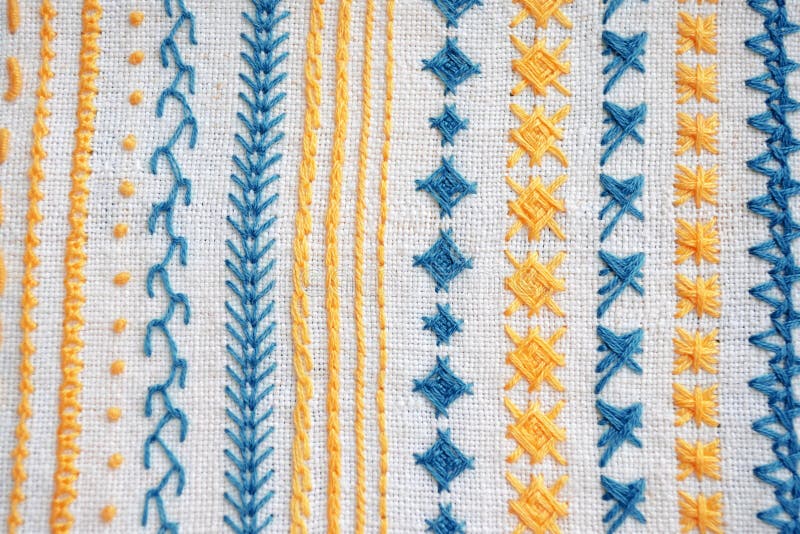 Different Yellow and Blue Patterns of Embroidery on White Fabric Stock ...