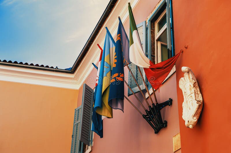 Different Flags in Flagpoles on the Wall of the Administrative Building ...