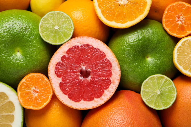Different Fresh Whole and Cut Citrus Fruits As Background, Top View ...