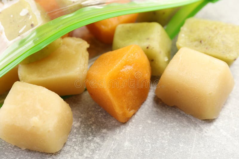 Different Frozen Fruit Puree Cubes in Plastic Bag on Table, Closeup ...